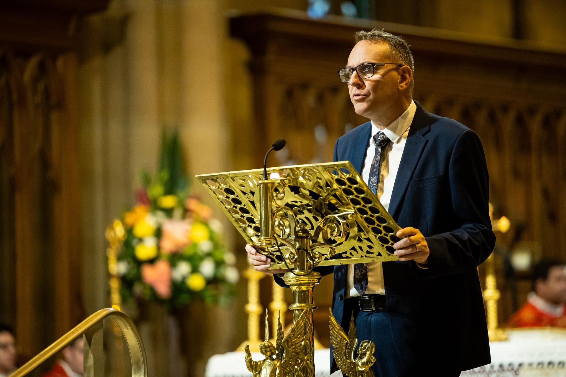 Matthew Armour proclaiming the First Reading