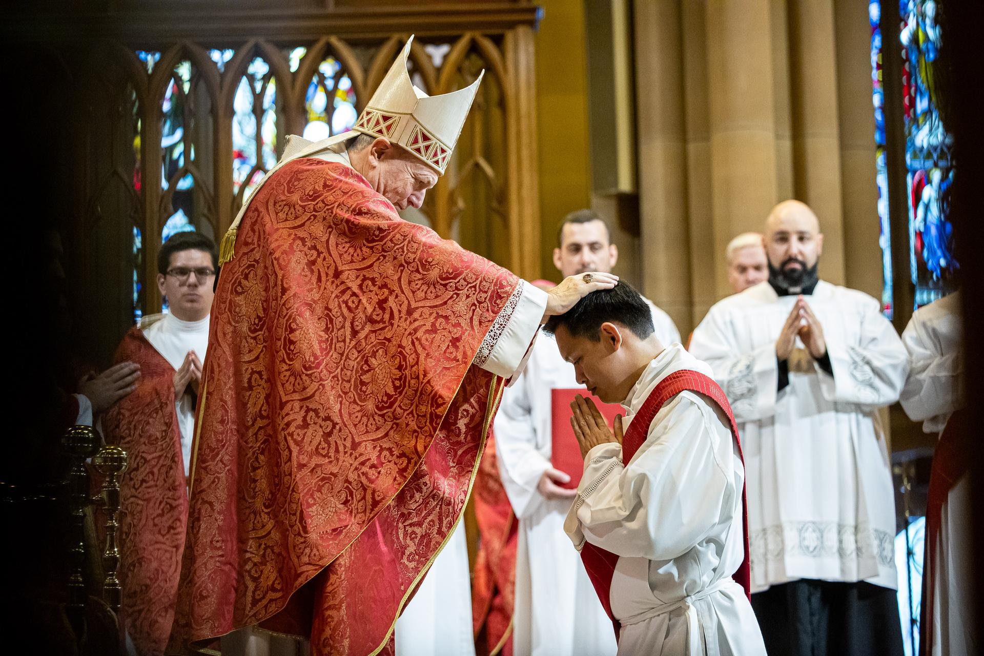 Archbishop Anthony Fisher OP laying hands upon Rev. Nonie. Photo ...