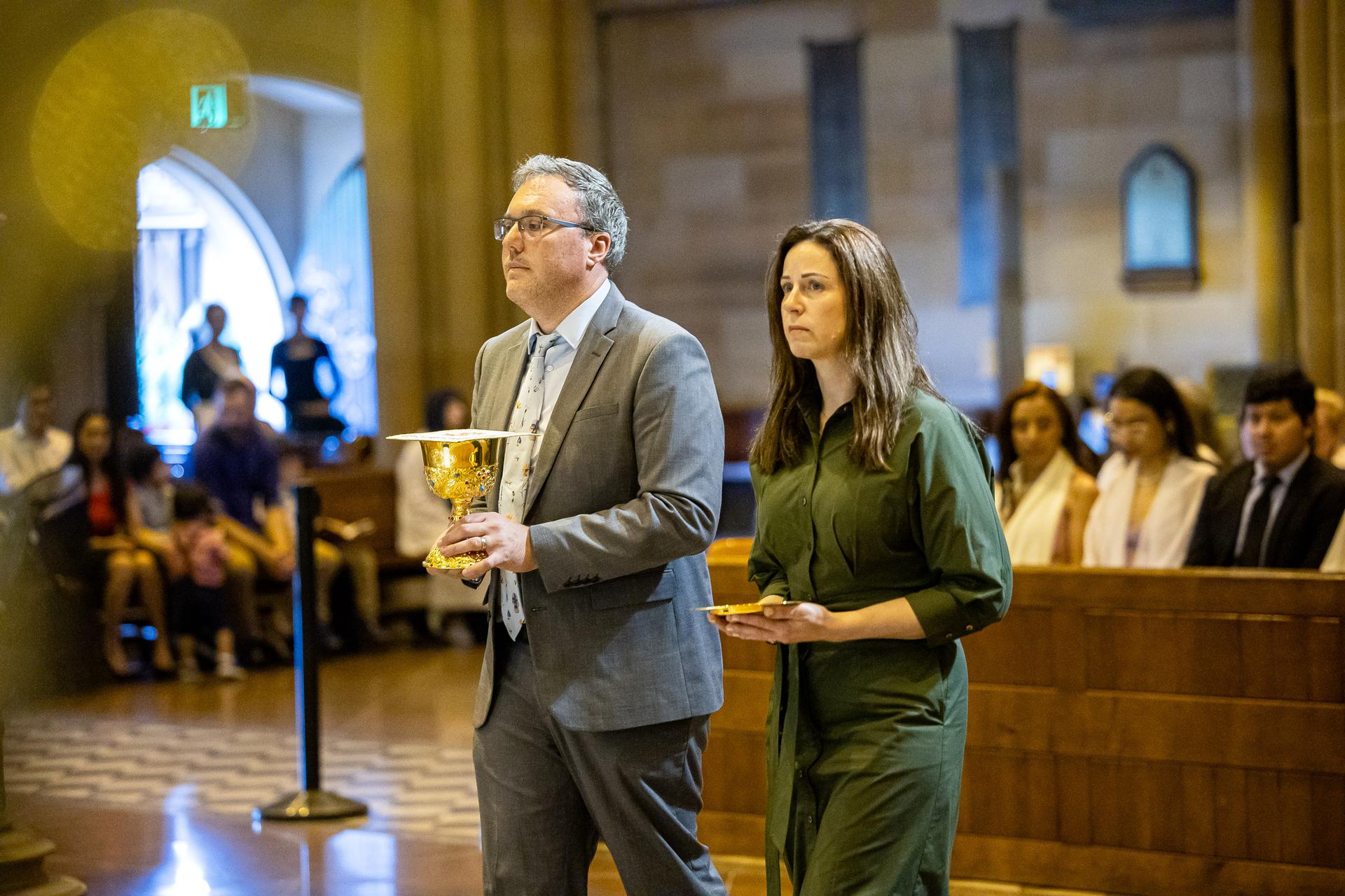 The Gifts of Bread and Wine were brought up in procession by Michael ...